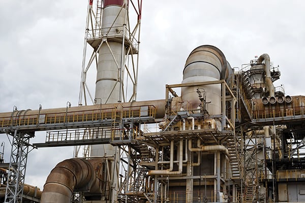 Old installation of a refinery with rusty pipes and peeling paint ...